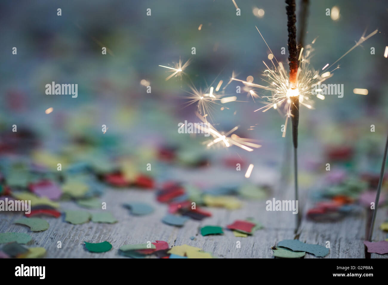 Burning Sparklers with colorful Confetti on wooden Table at a Party ...