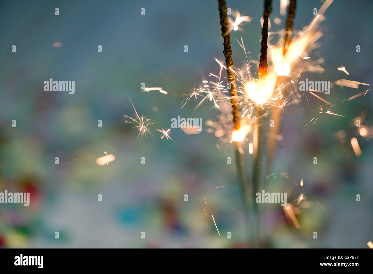 Burning Sparklers with colorful Confetti on wooden Table at a Party ...
