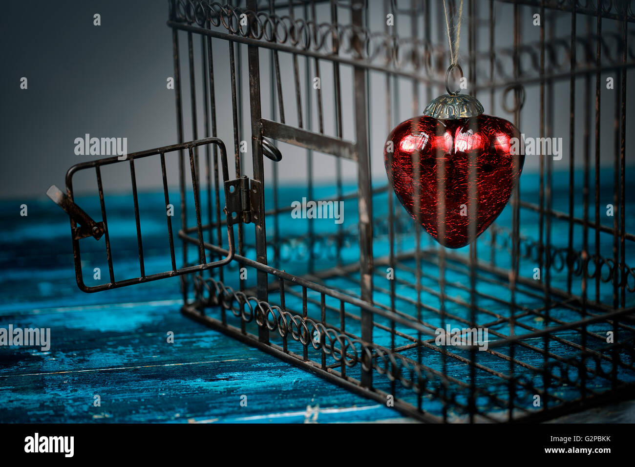 Red Heart trapped inside an old rusty bird cage Stock Photo - Alamy