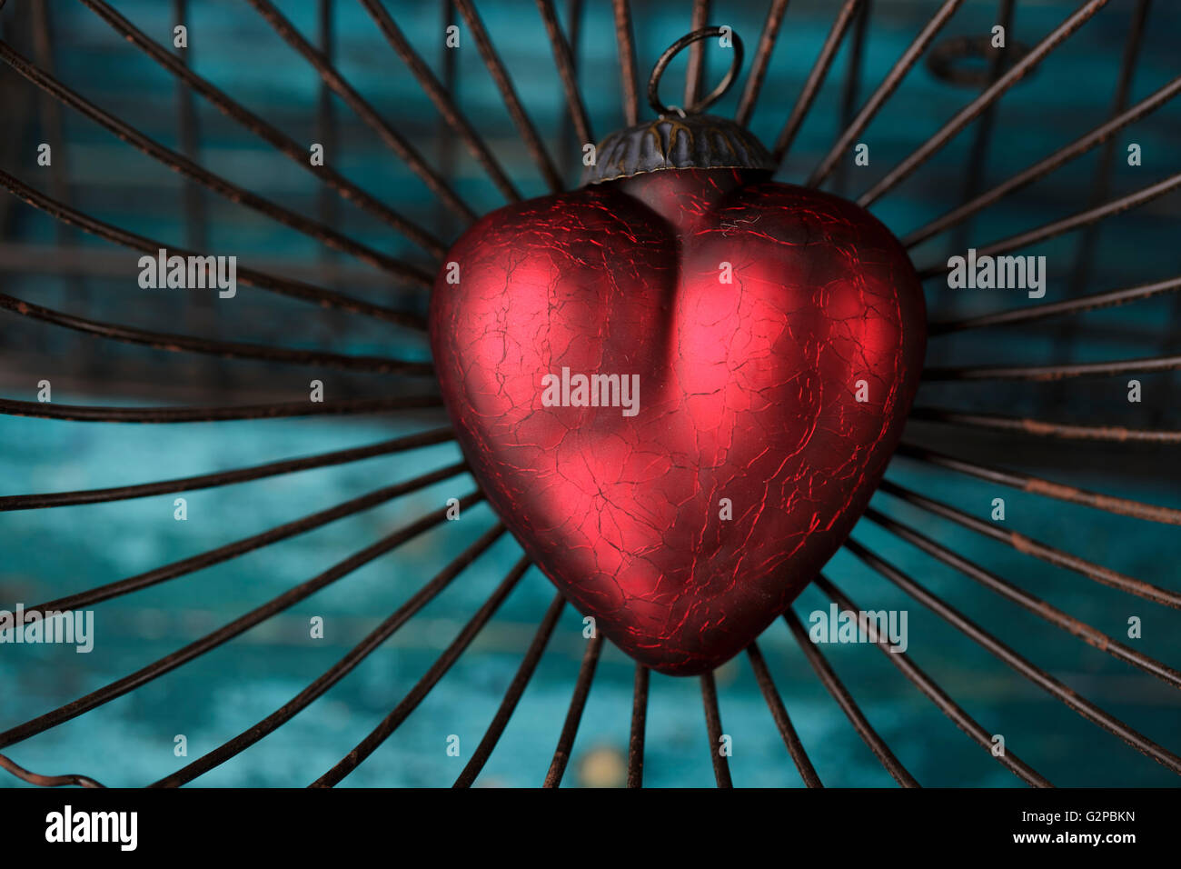 Red Heart trapped inside an old rusty bird cage Stock Photo - Alamy