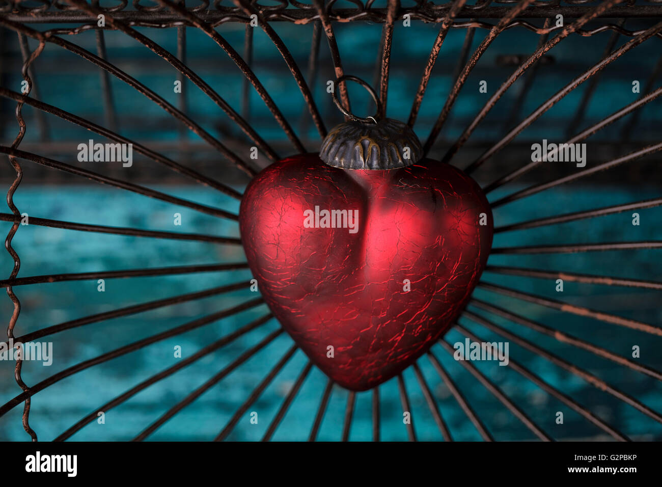 Red Heart trapped inside an old rusty bird cage Stock Photo - Alamy