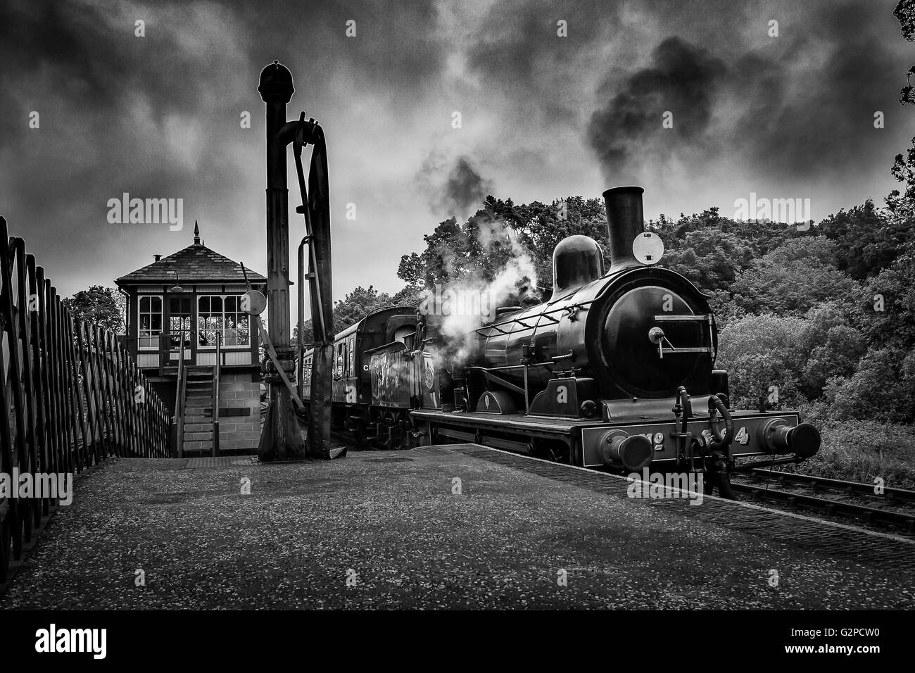 Steam Train steaming along the tracks and coming into the station on ...