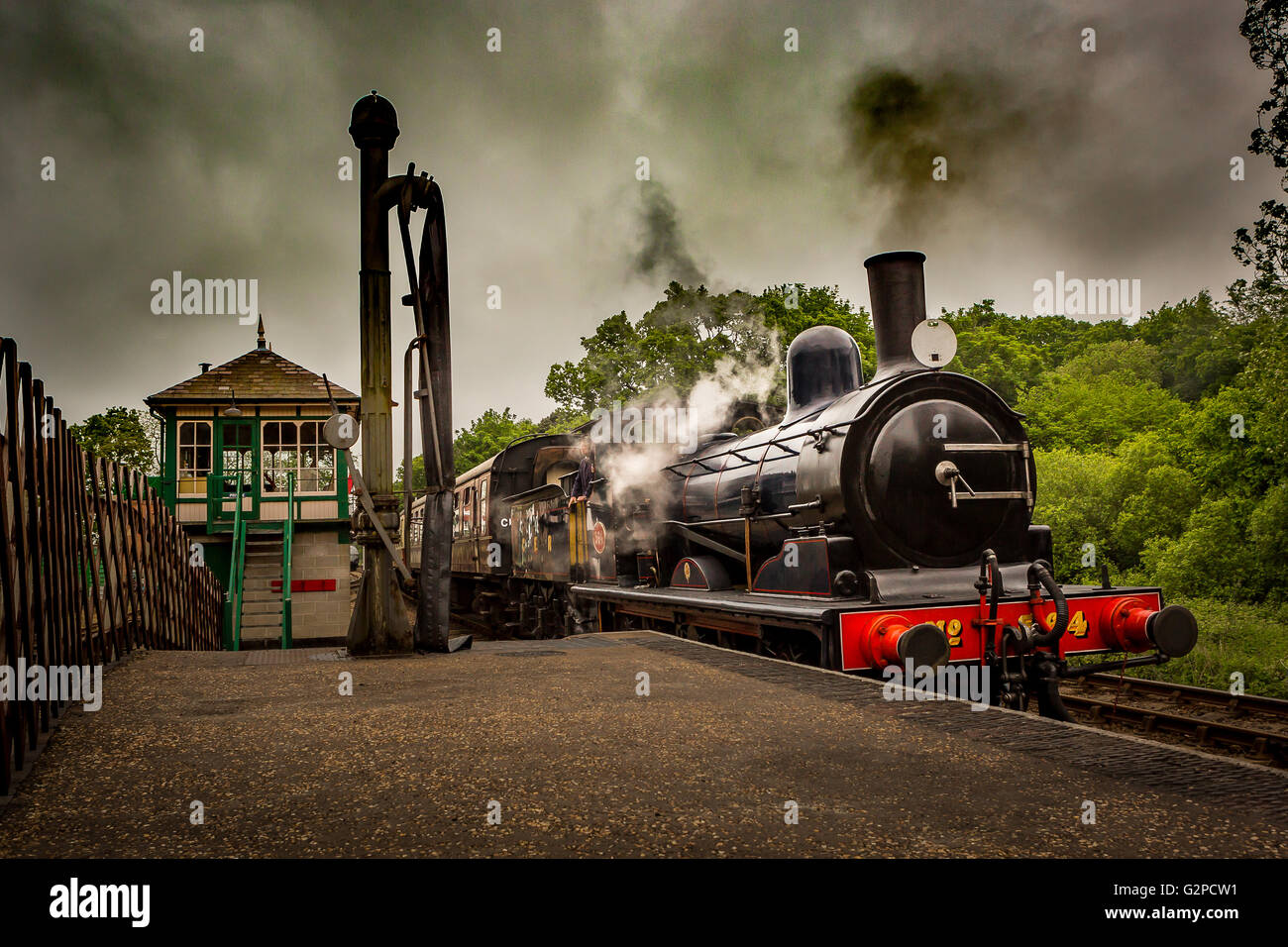 Steam Train steaming along the tracks and coming into the station on ...