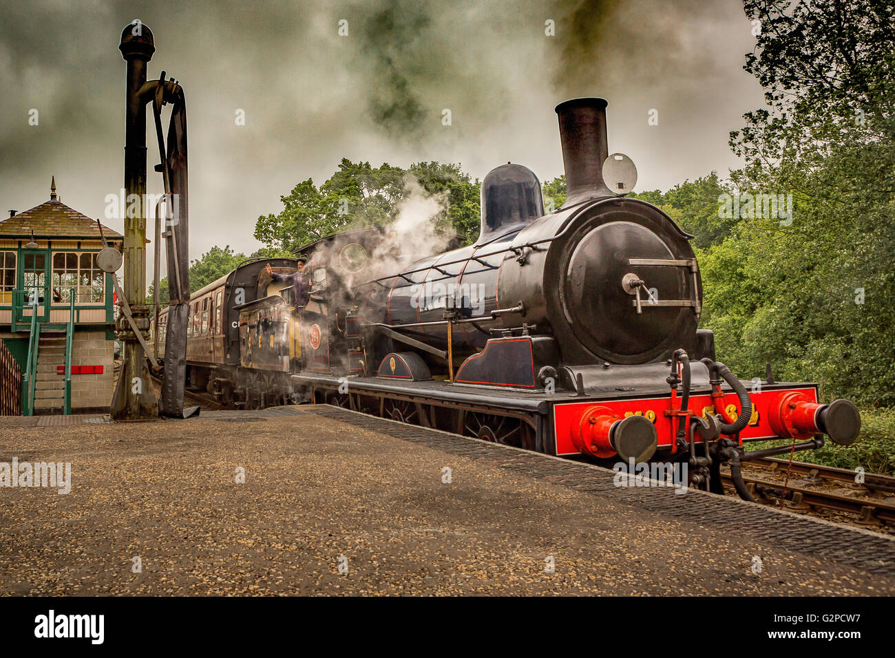 Steam Train steaming along the tracks and coming into the station on ...