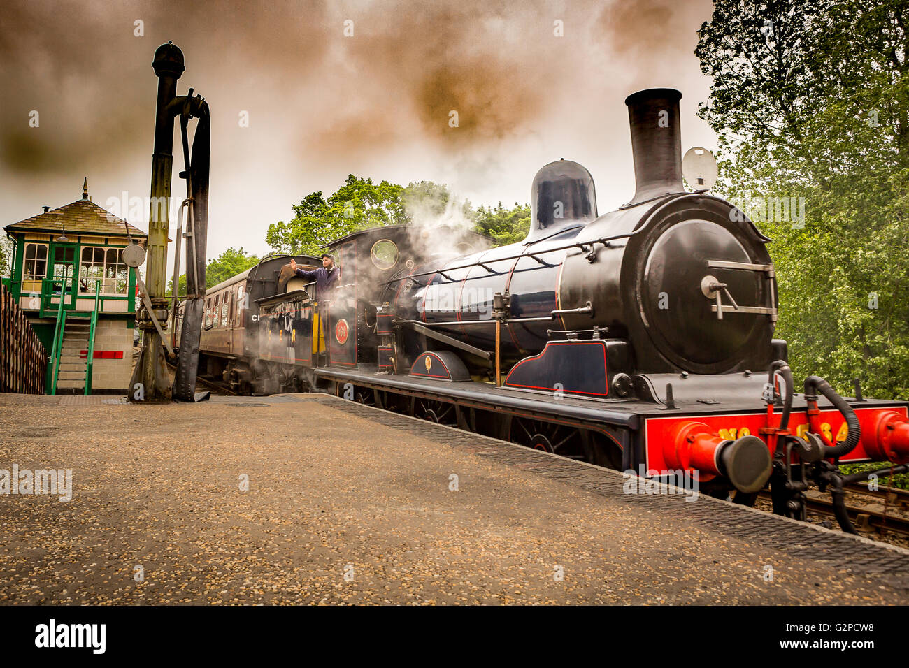 Steam Train steaming along the tracks and coming into the station on ...