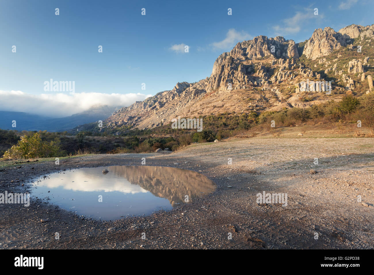Mountain landscape with blue sky reflection in puddle at sunset Stock ...