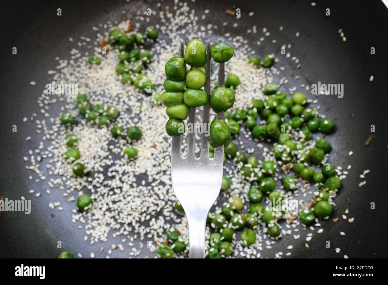 Peas on a fork. Colorful background Stock Photo - Alamy