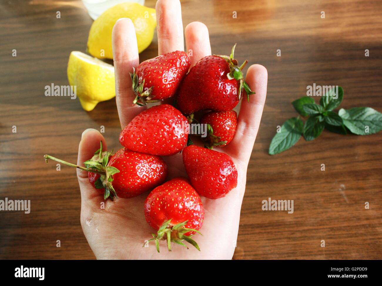 Fresh strawberry in hand Stock Photo - Alamy