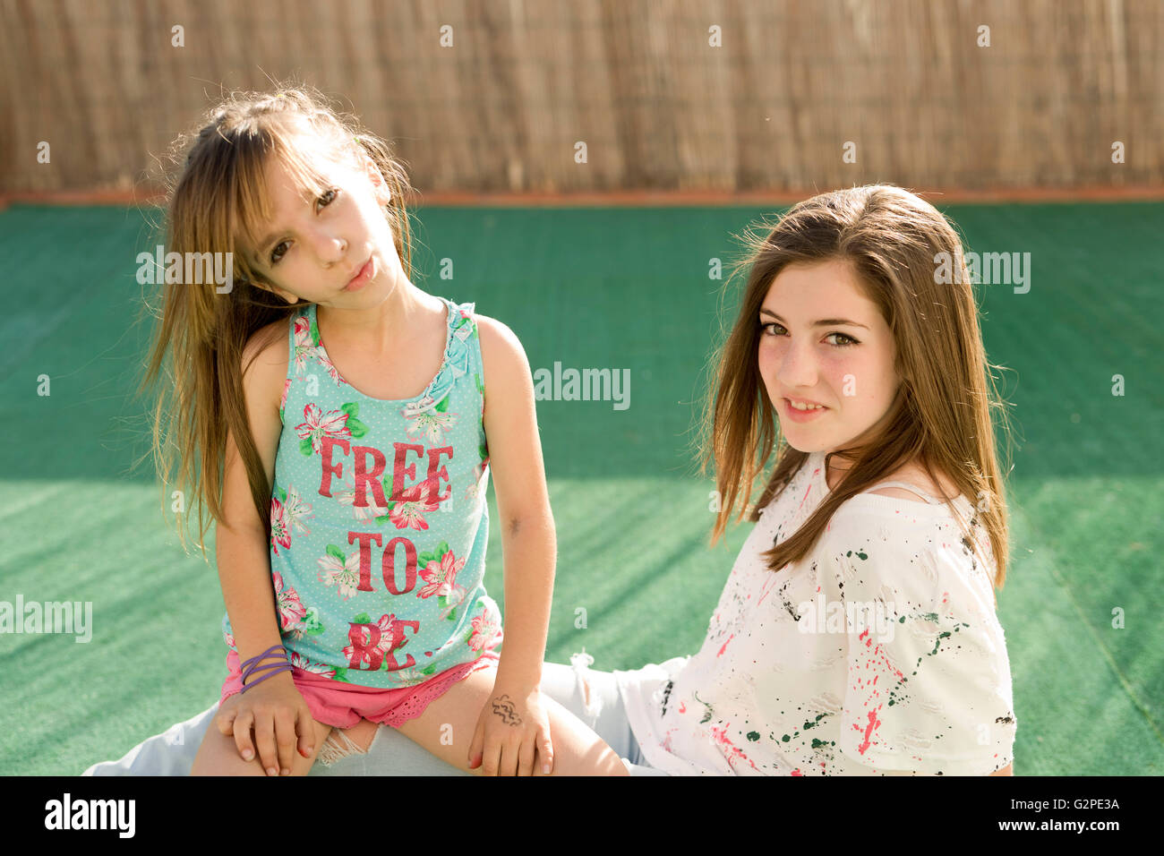 portrait of two sisters outdoors with natural light Stock Photo - Alamy
