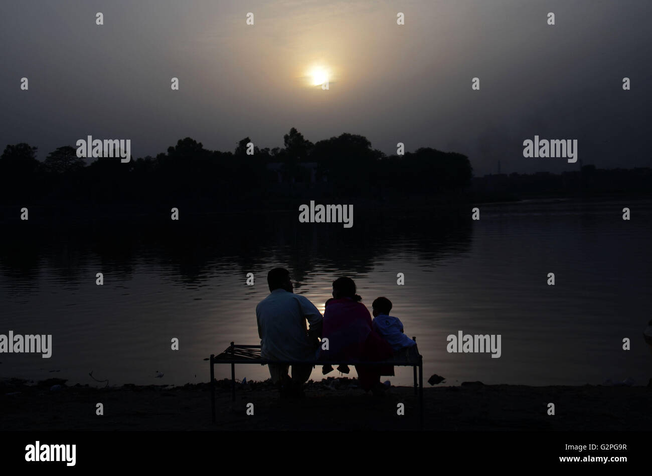 Lahore, Pakistan. 01st June, 2016. Pakistani parents with their ...
