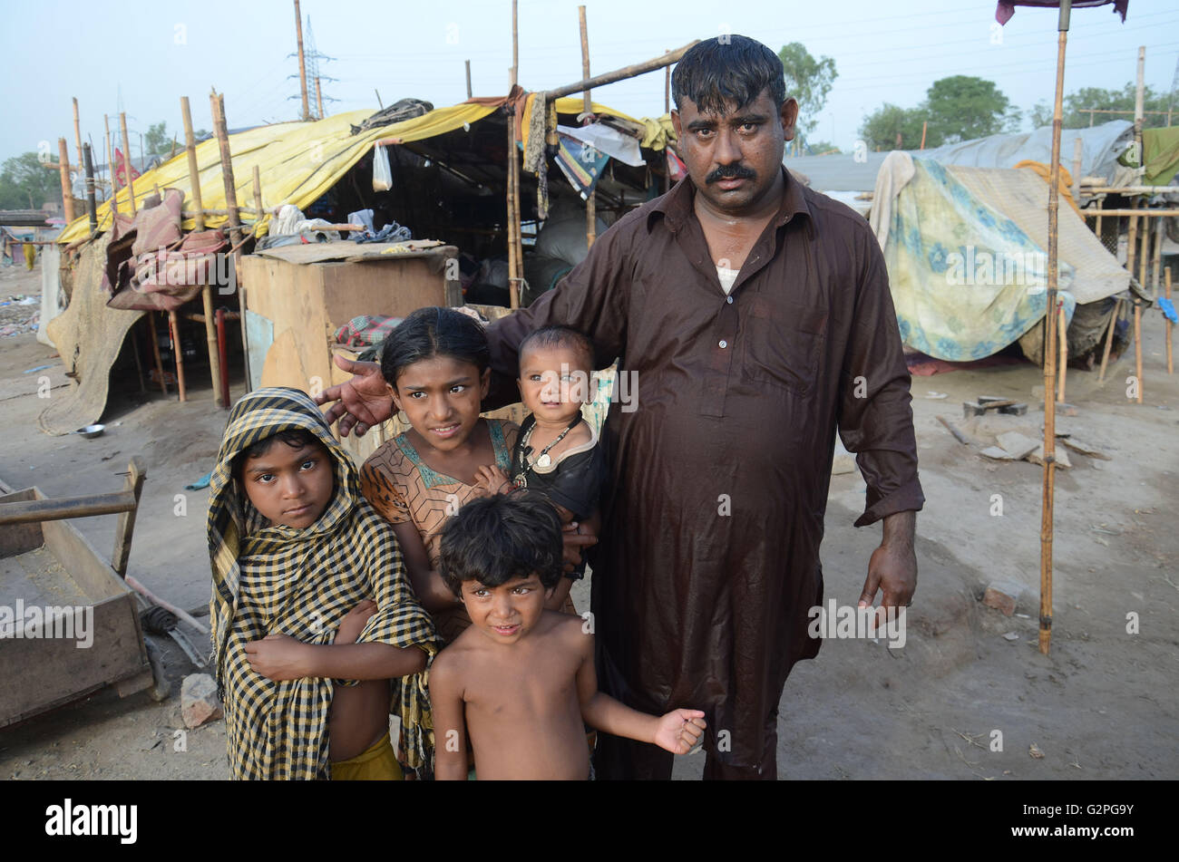 Lahore, Pakistan. 01st June, 2016. Pakistani parents with their ...