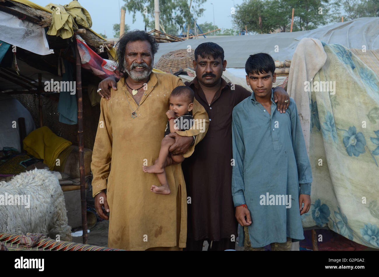 Lahore, Pakistan. 01st June, 2016. Pakistani parents with their ...