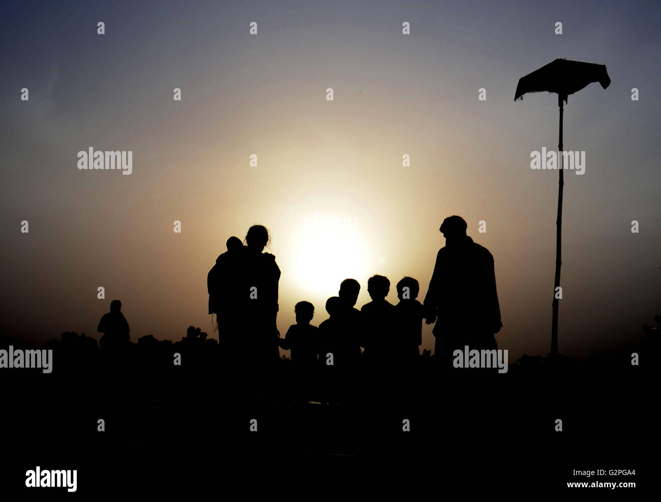 Lahore, Pakistan. 01st June, 2016. Pakistani parents with their ...