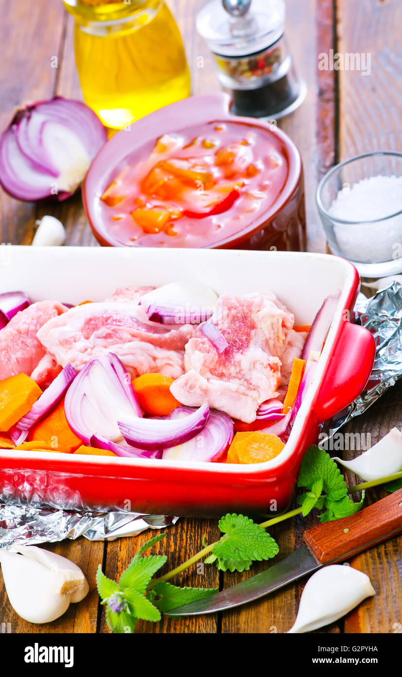 raw meat with vegetables in the bowl and on a table Stock Photo - Alamy