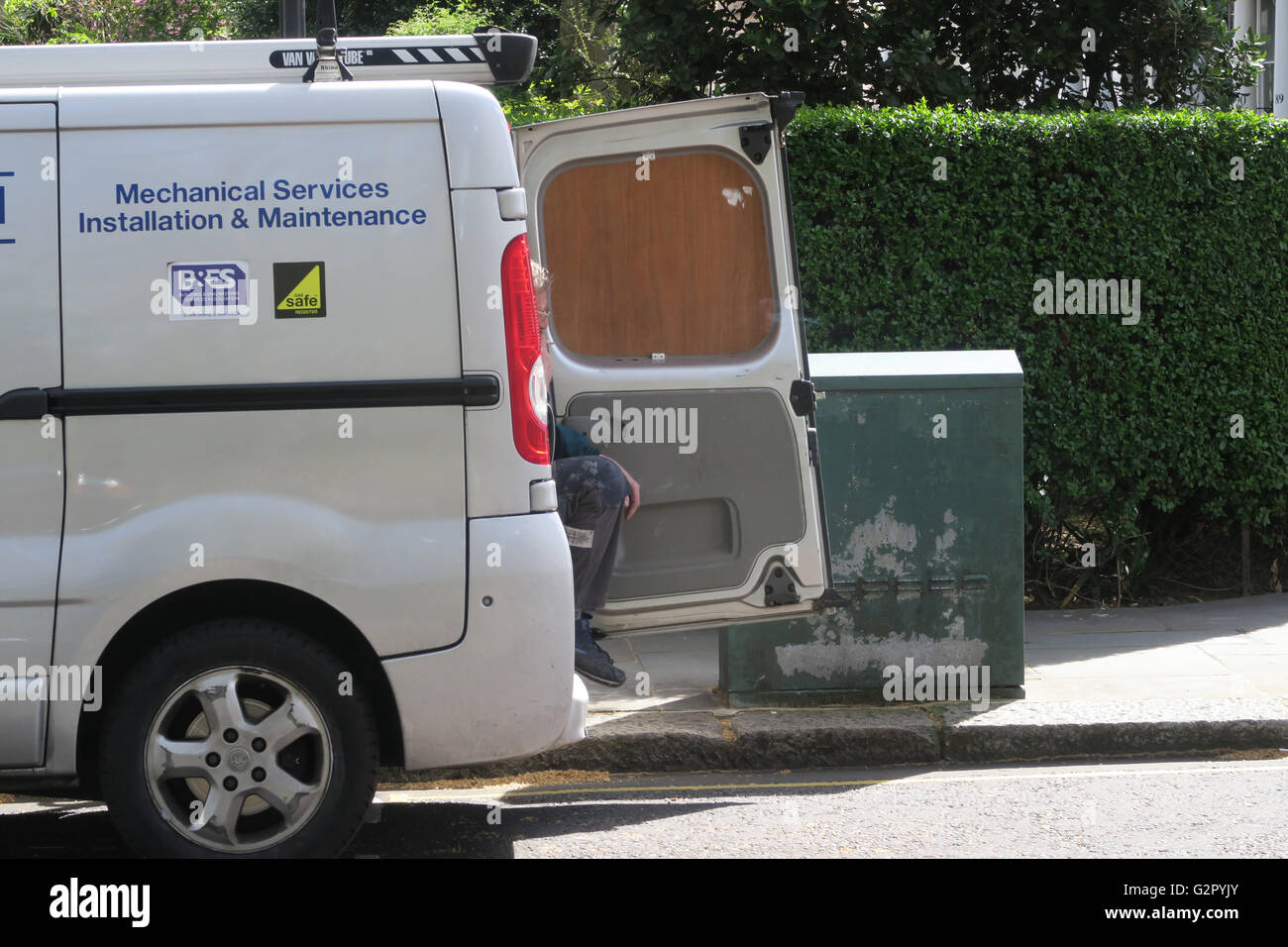 workman sits in the back of van Stock Photo - Alamy