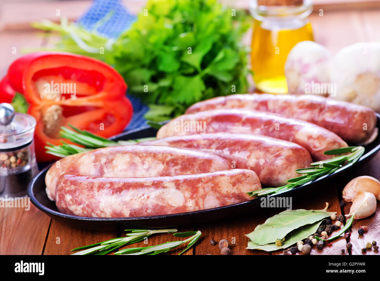raw sausages on plate and on a table Stock Photo - Alamy