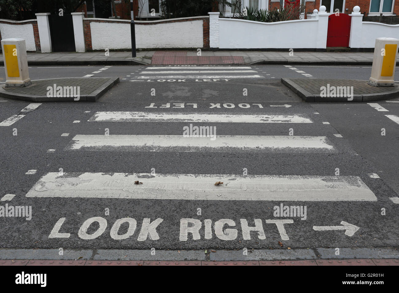 pedestrian crossing with look right, left road markings, bollards ...
