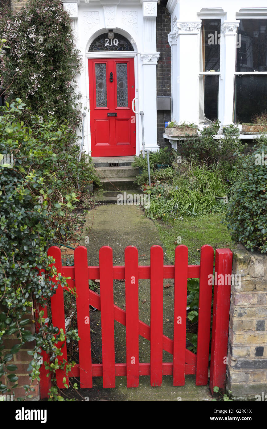 Red house door and red front gate Stock Photo - Alamy