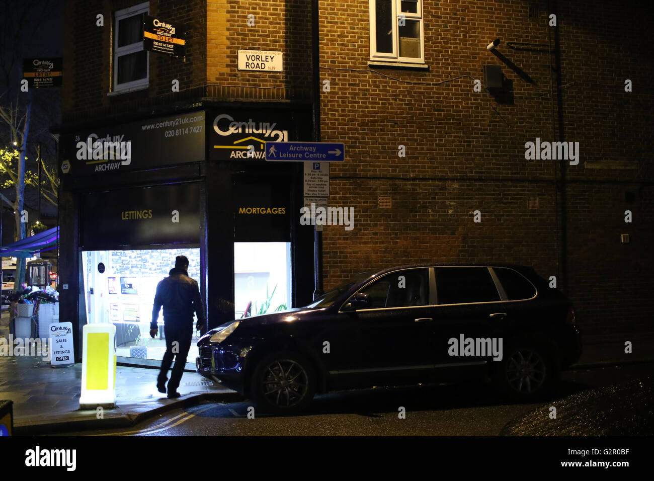 Man outside a shop at night Stock Photo - Alamy