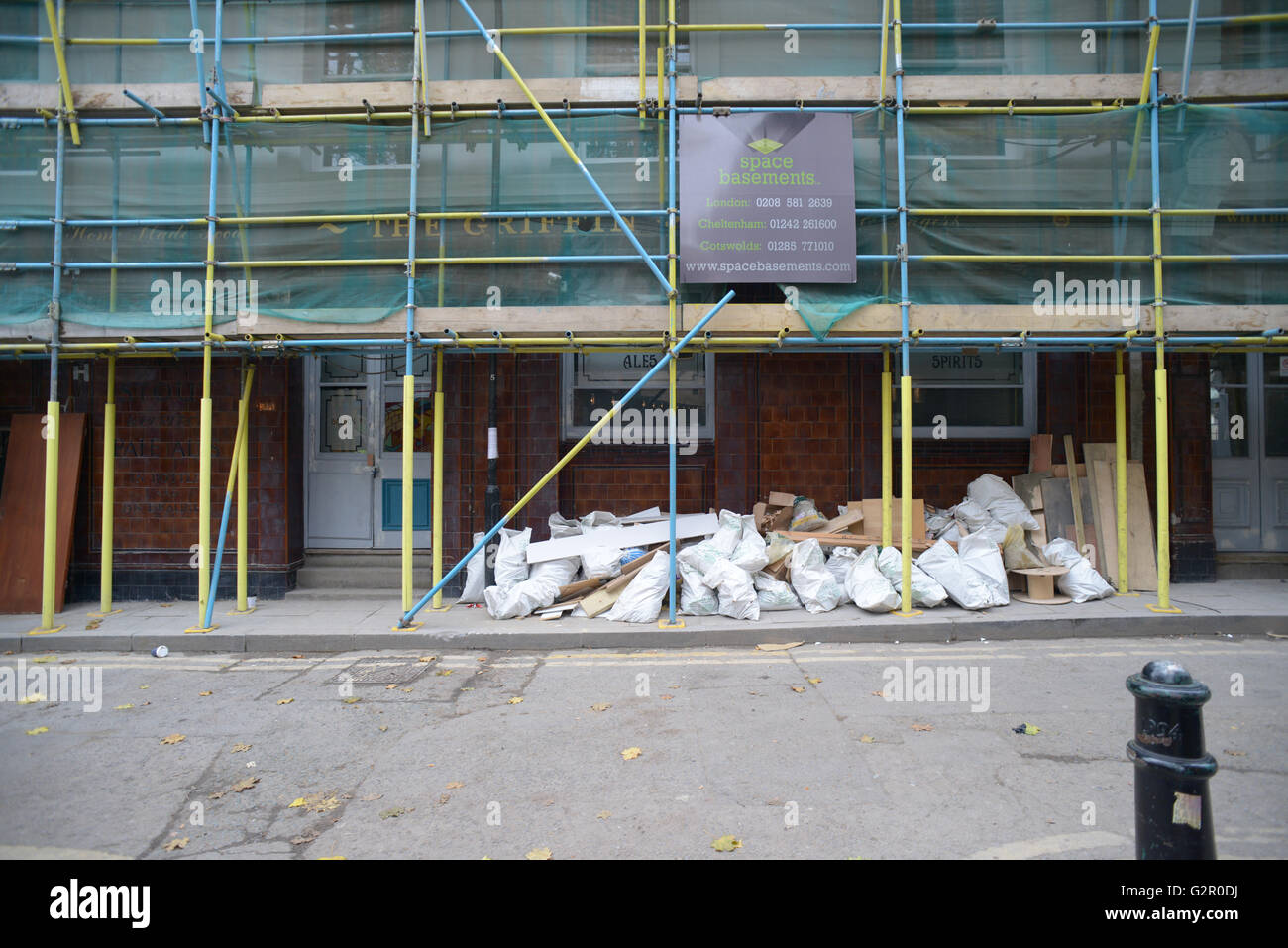 sacks of construction rubbish outside a building under redevelopment ...