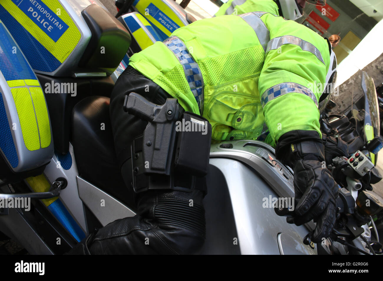 Metropolitan Police firearms officer on a motorcycle, Glock pistol at ...