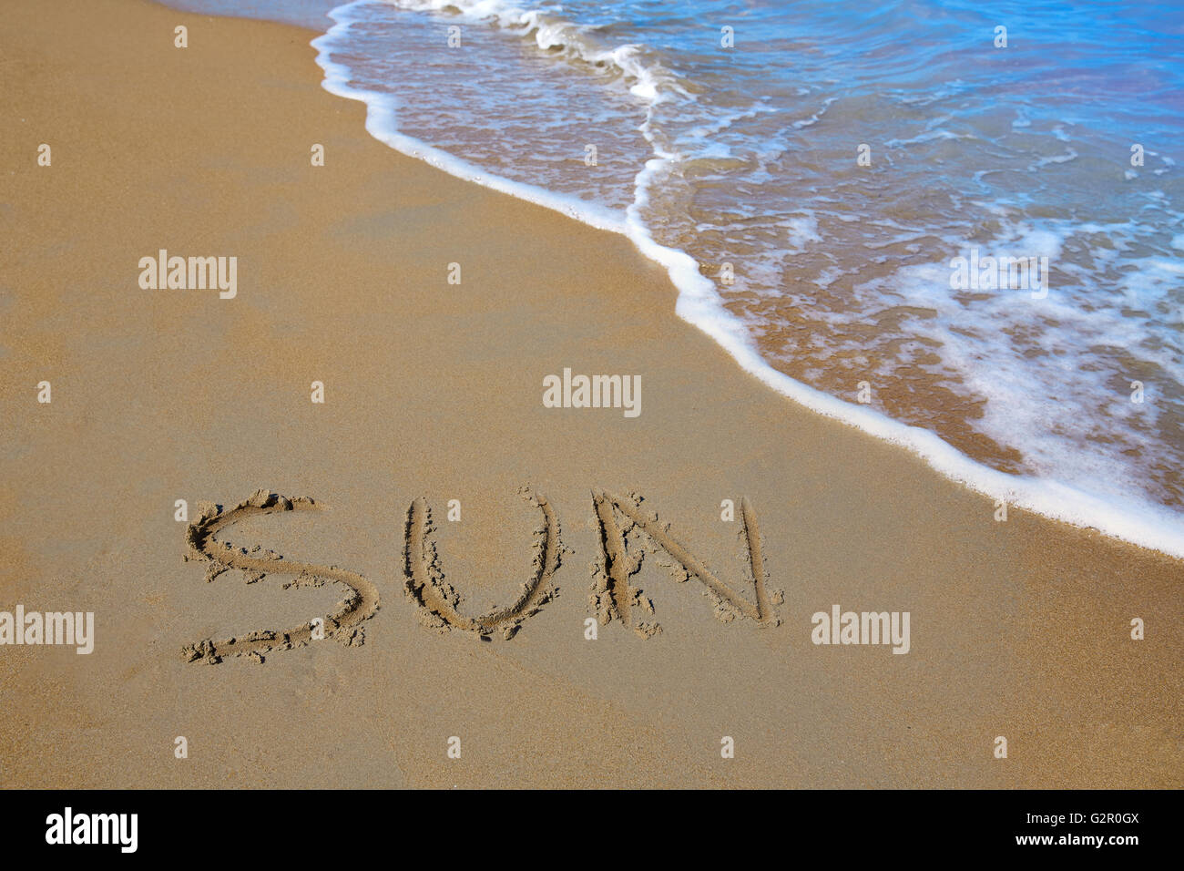 Sun spell written work in sand of a beach in vacation Stock Photo - Alamy