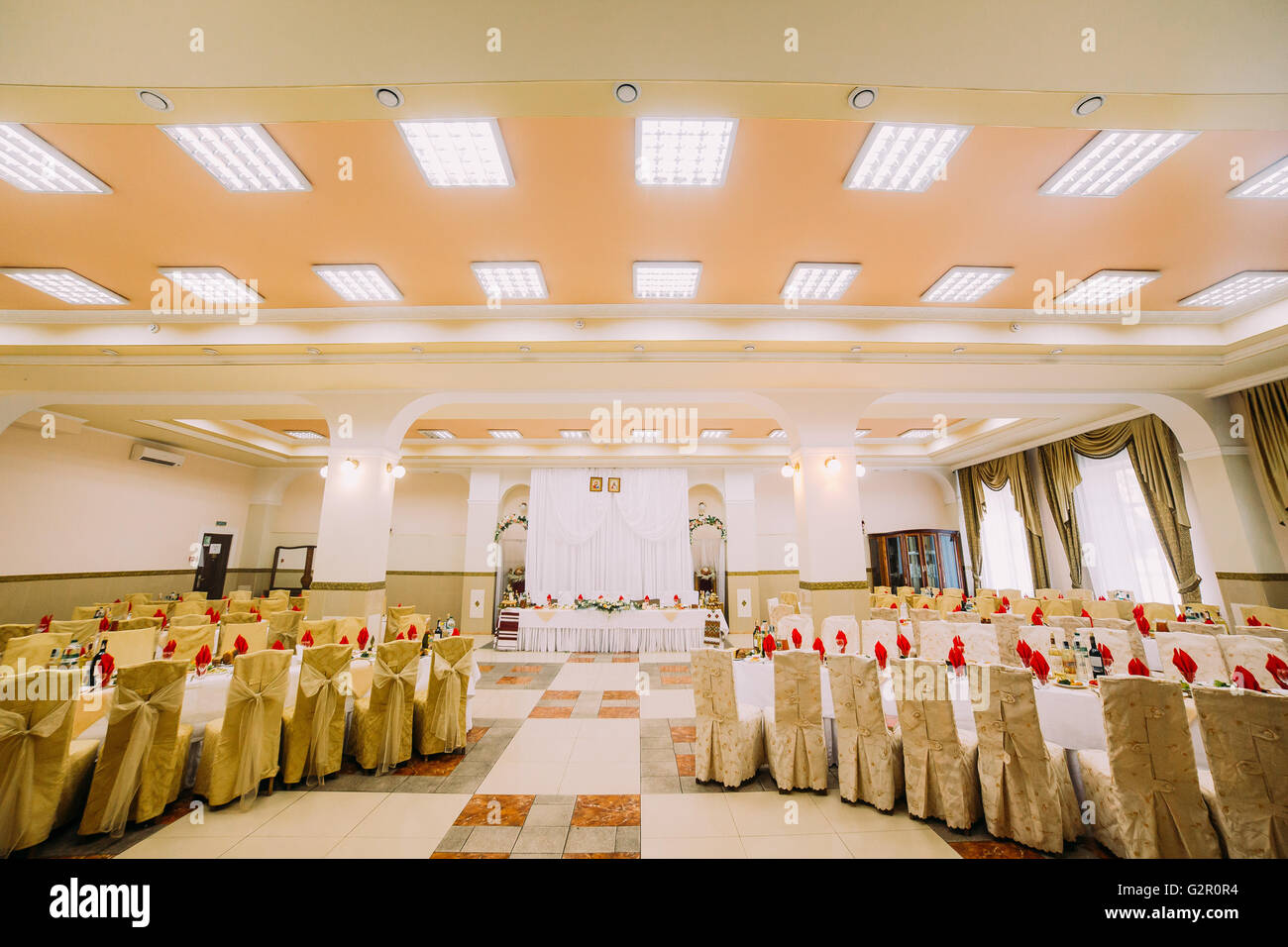 Interior of luxury wedding hall with rich decorated head table at ...