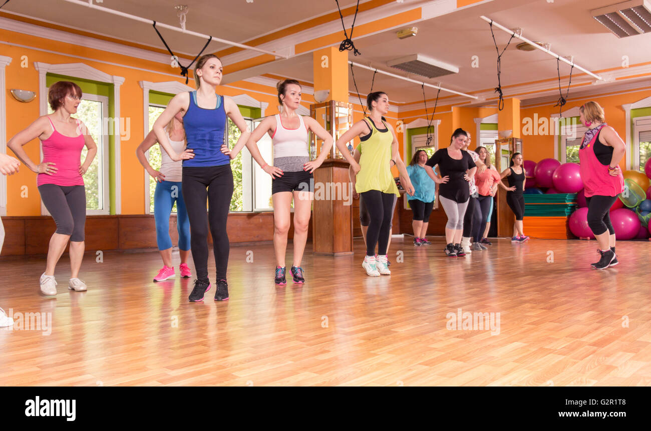 Group of women training instructor, indoors Stock Photo - Alamy