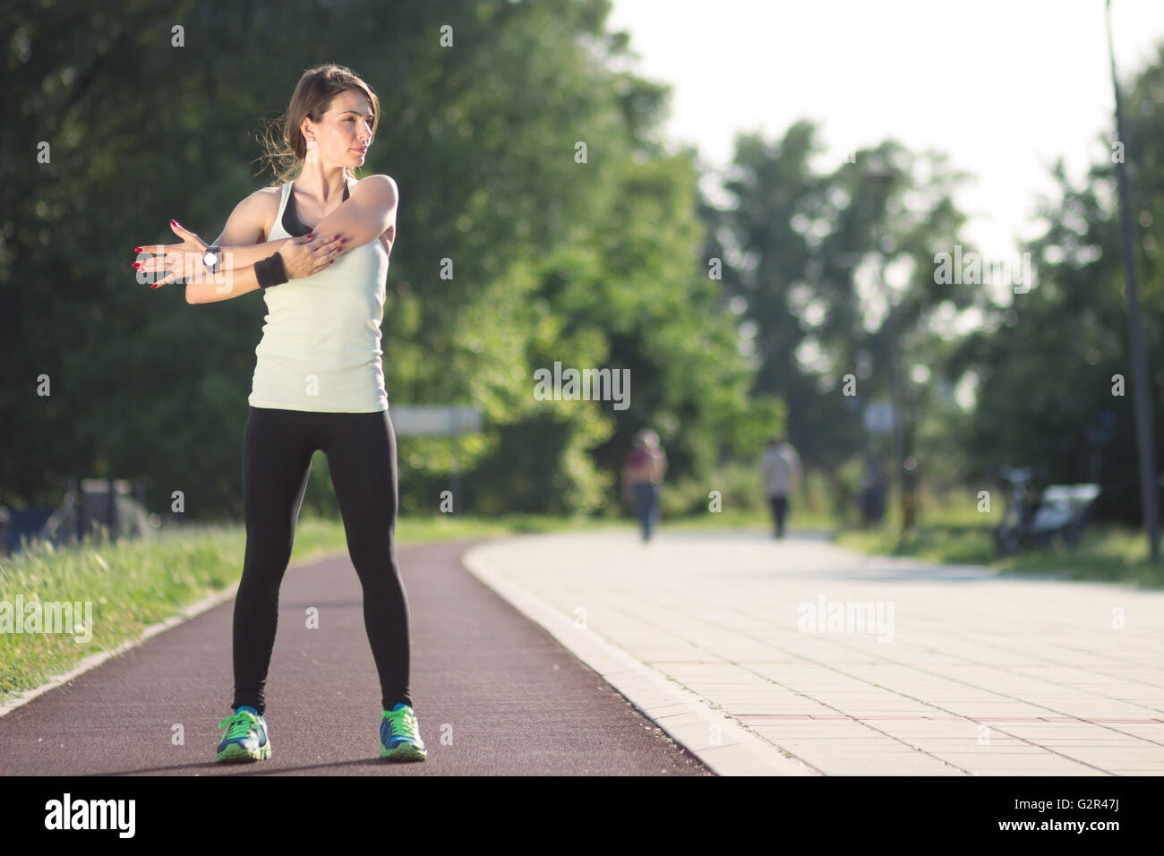 Girl stretch arm, outdoors, track Stock Photo - Alamy