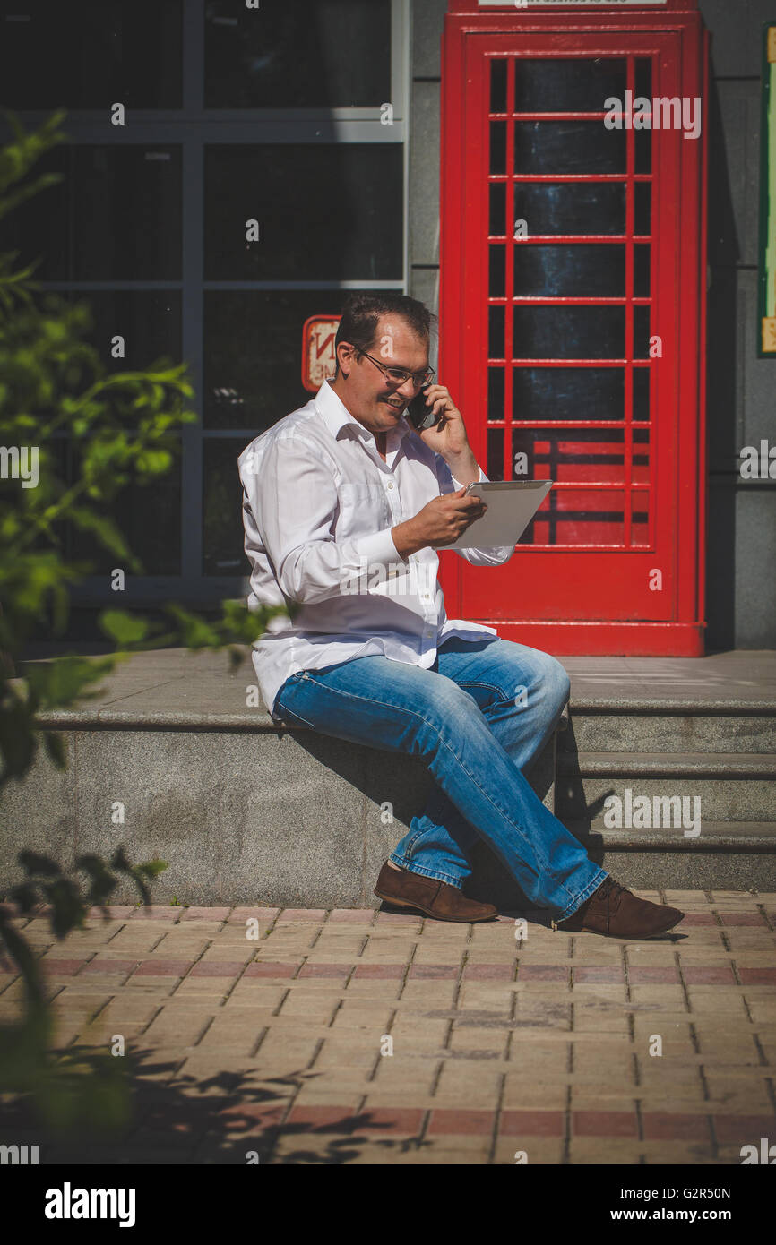 Business man using mobile phone red classic English telephone box Stock ...