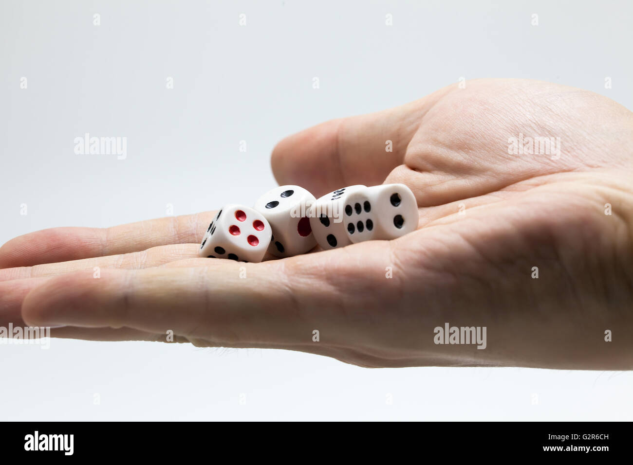 Human hand ready to roll the dice on white isolated background - Try ...