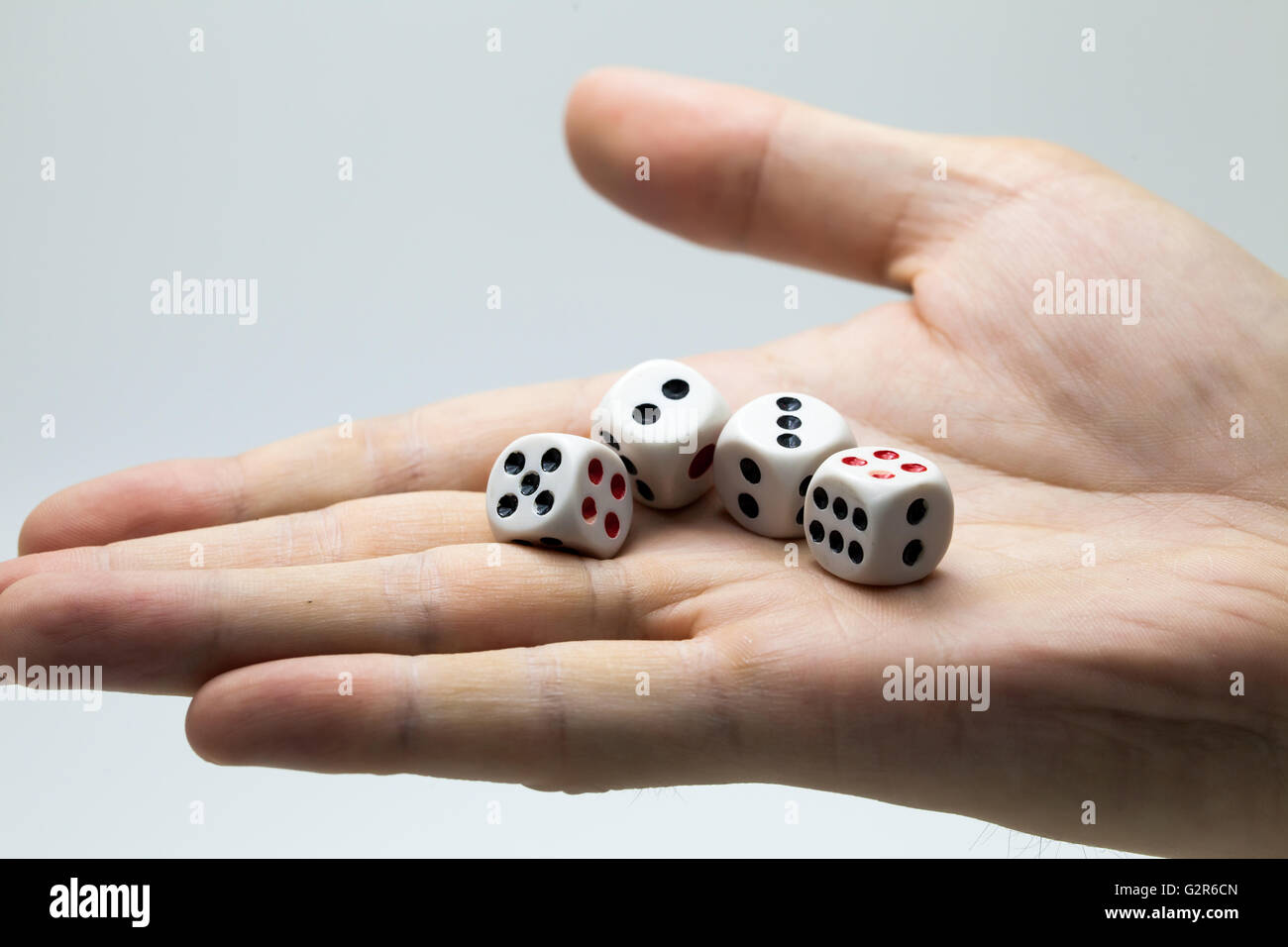 Human hand ready to roll the dice on white isolated background - Try ...