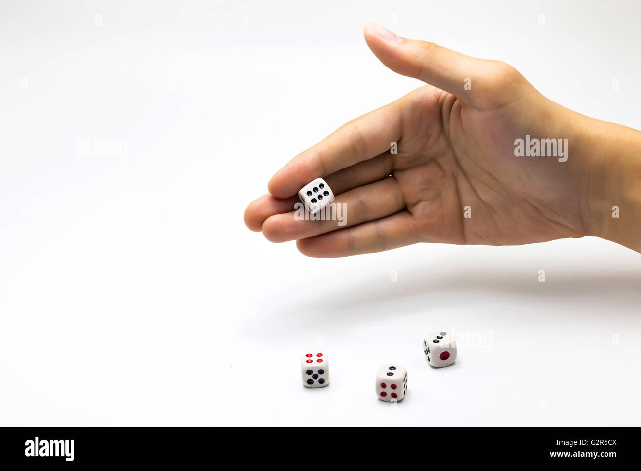 Human hand ready to roll the dice on white isolated background - Try ...