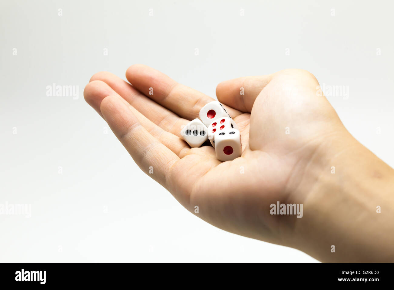 Human hand ready to roll the dice on white isolated background - Try ...
