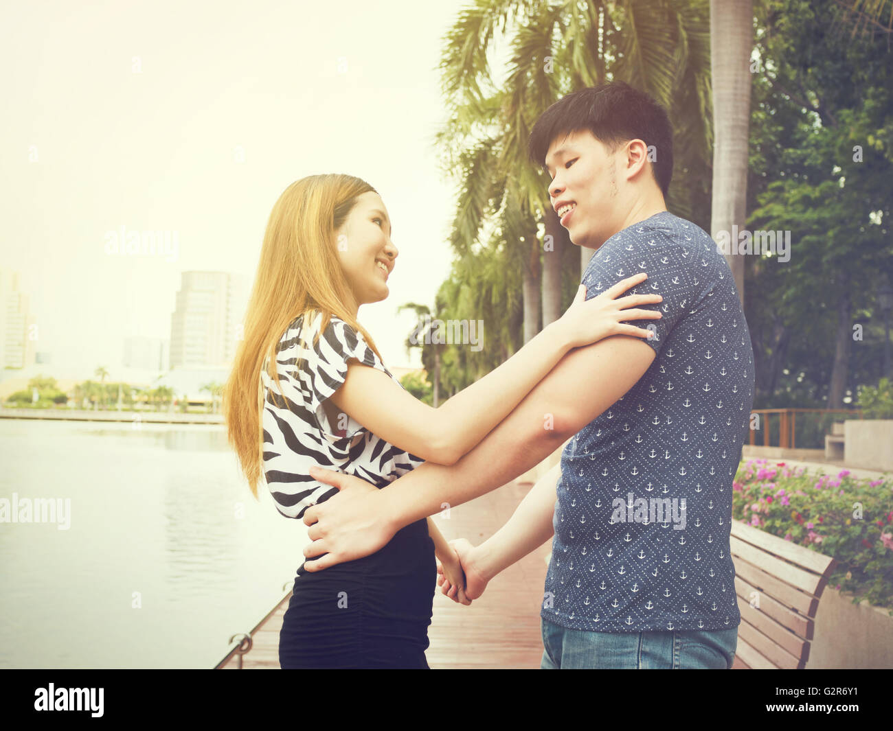 Portrait of Asian couple holding and dancing in the public park Stock ...