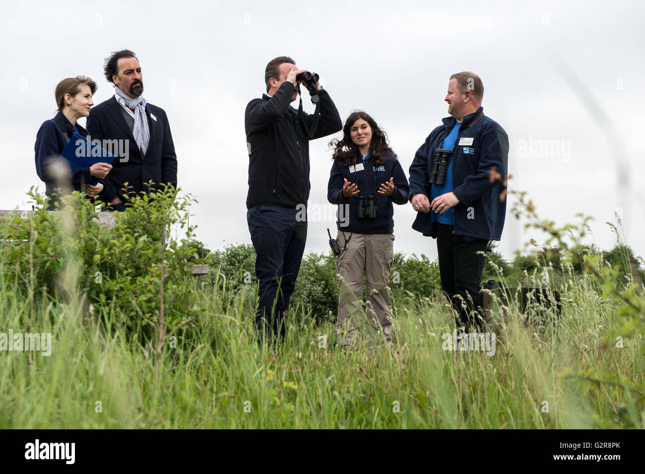 Prime Minister David Cameron (centre) is shown around RSPB nature ...