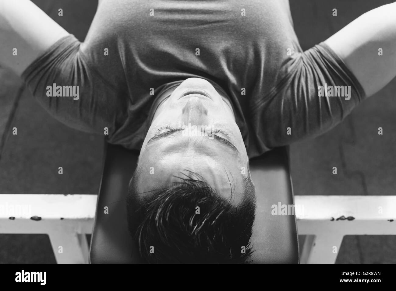 Top view of attractive young muscular man lifting weight while working ...