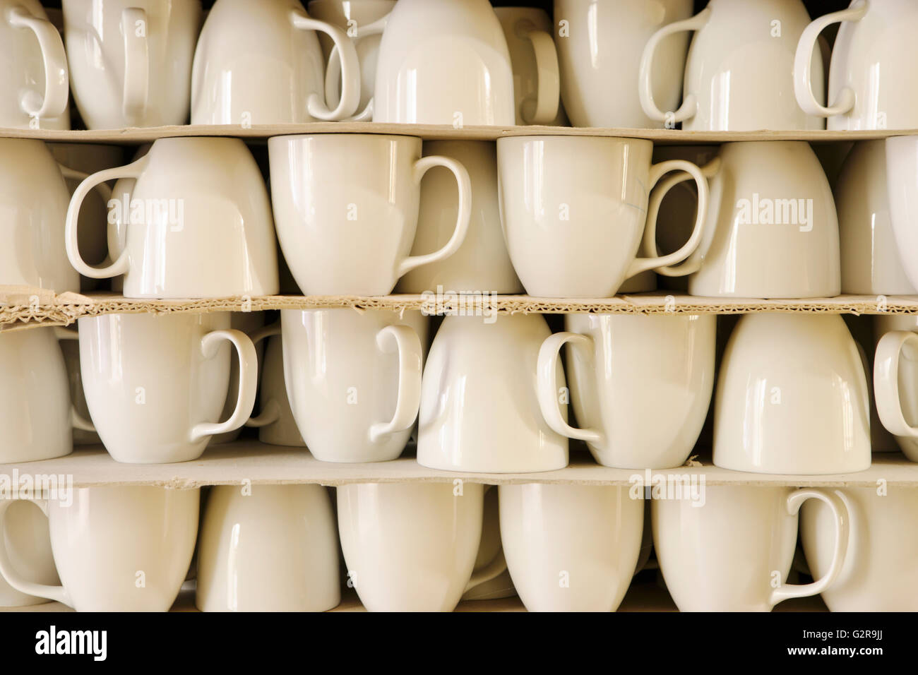 Cups piled between cardboard Stock Photo - Alamy