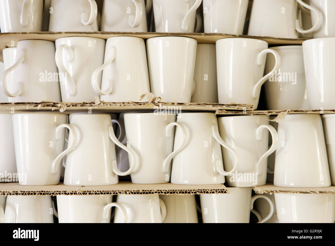 Cups piled between cardboard Stock Photo - Alamy