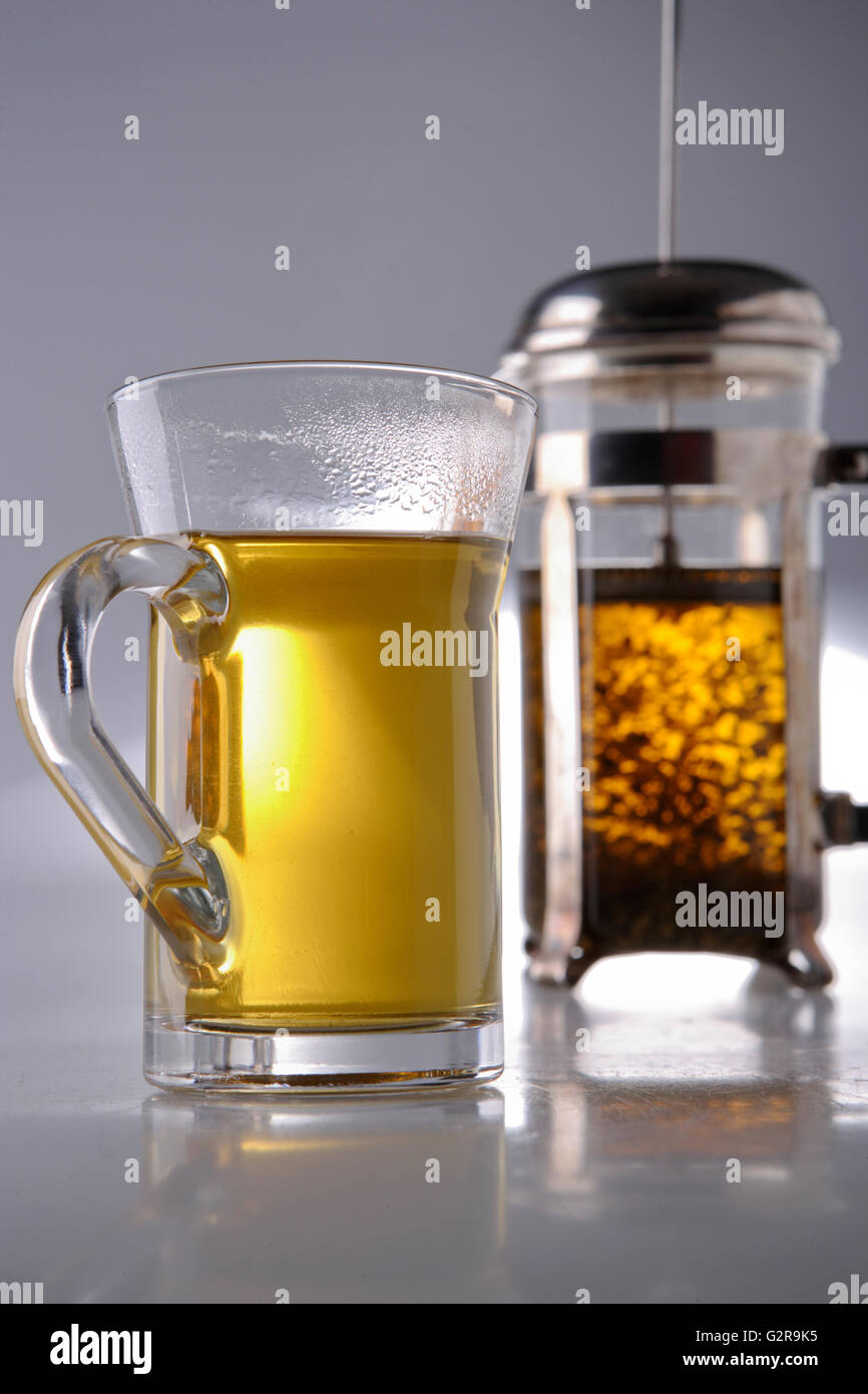 Tea glass in front of a teapot with herbal tea Stock Photo - Alamy