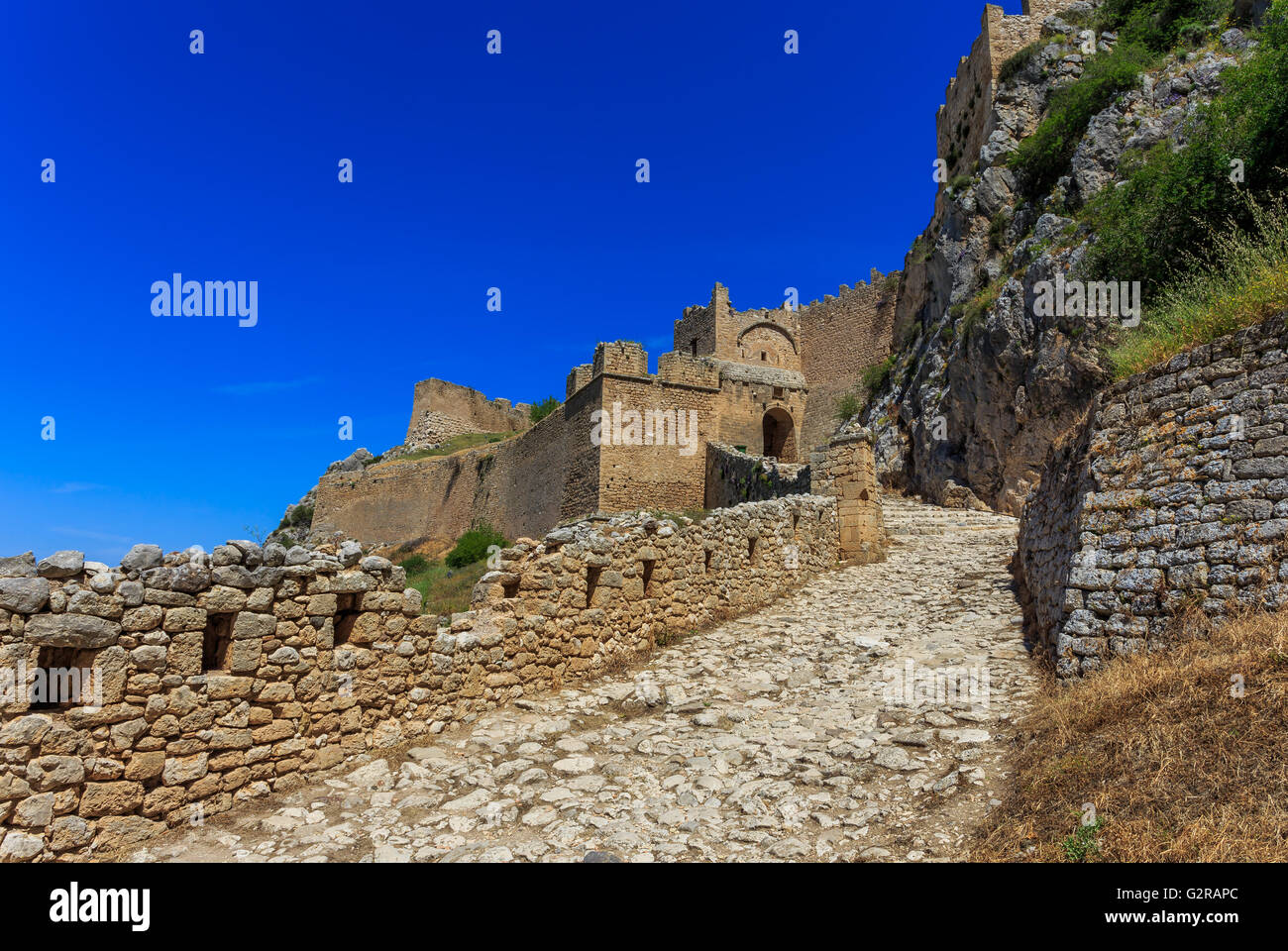 medieval fortress of Acrocorinth up on the hill against clear blue sky ...