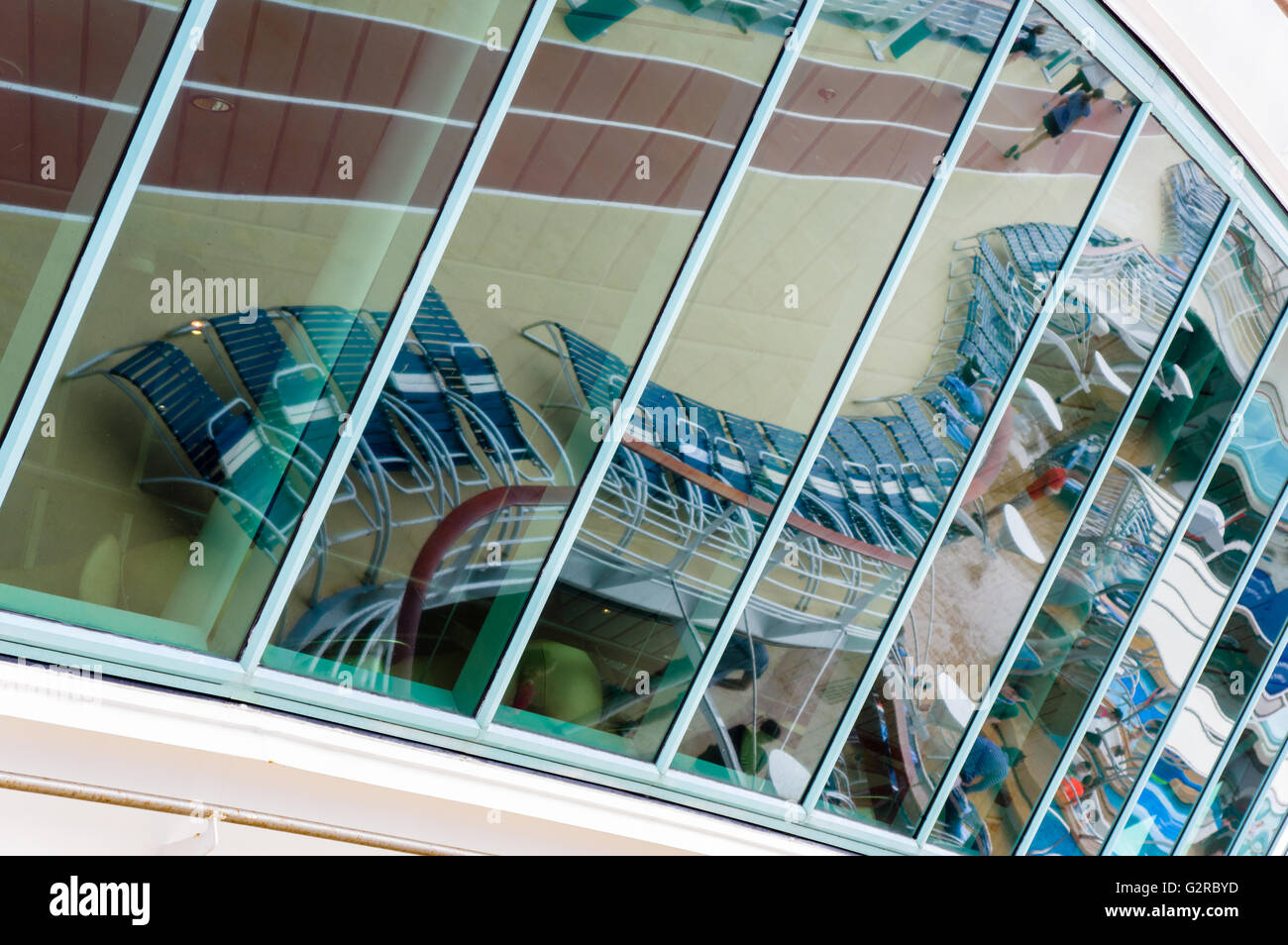 Deck chairs reflected in the windows of a cruise ship Stock Photo - Alamy