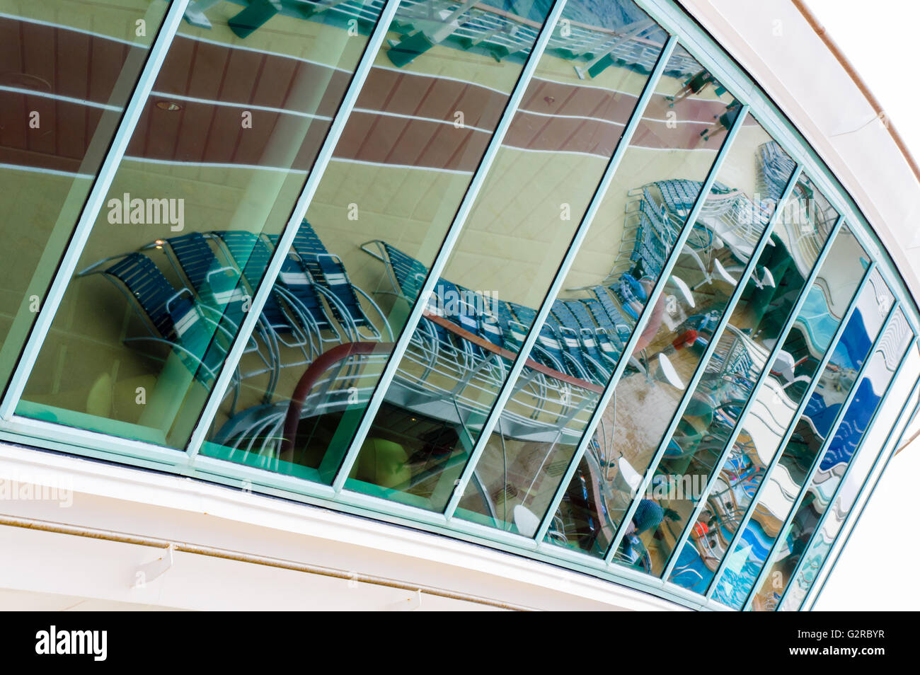 Deck chairs reflected in the windows of a cruise ship Stock Photo - Alamy