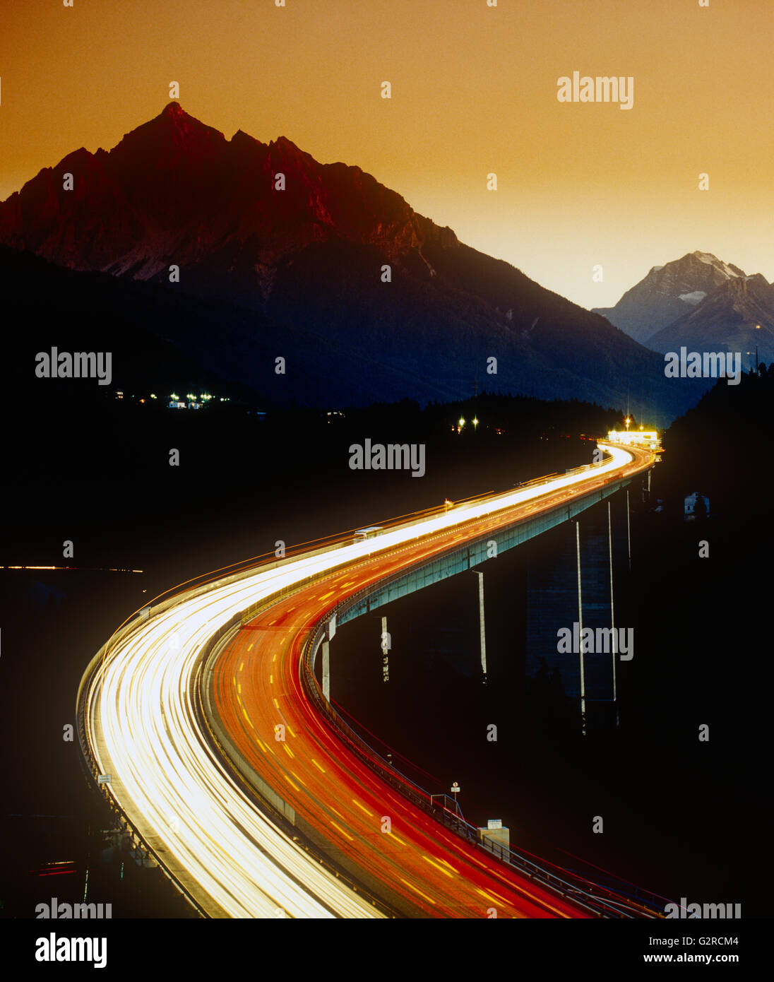 Slow shutter speed of lights from the cars coming across a bridge Stock ...