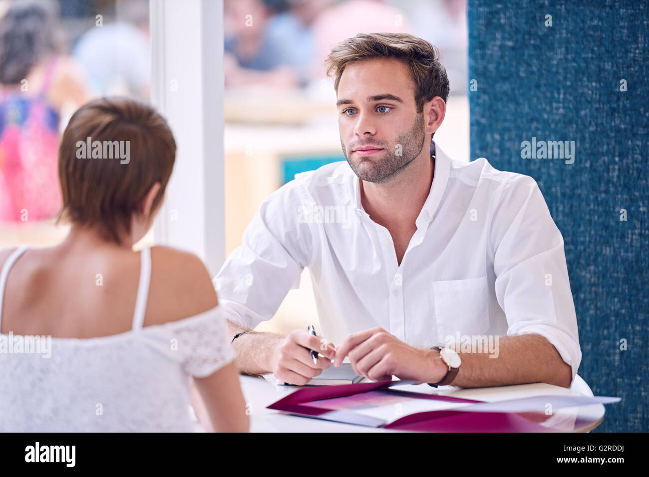 Businessman paying attention to his female partner during business ...