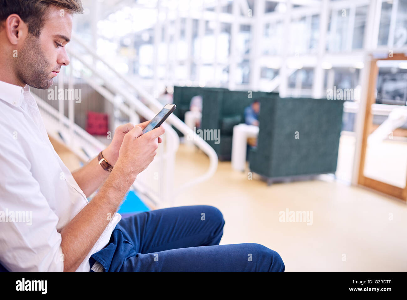 Adult man busy texting on his modern light weight smartphone Stock ...