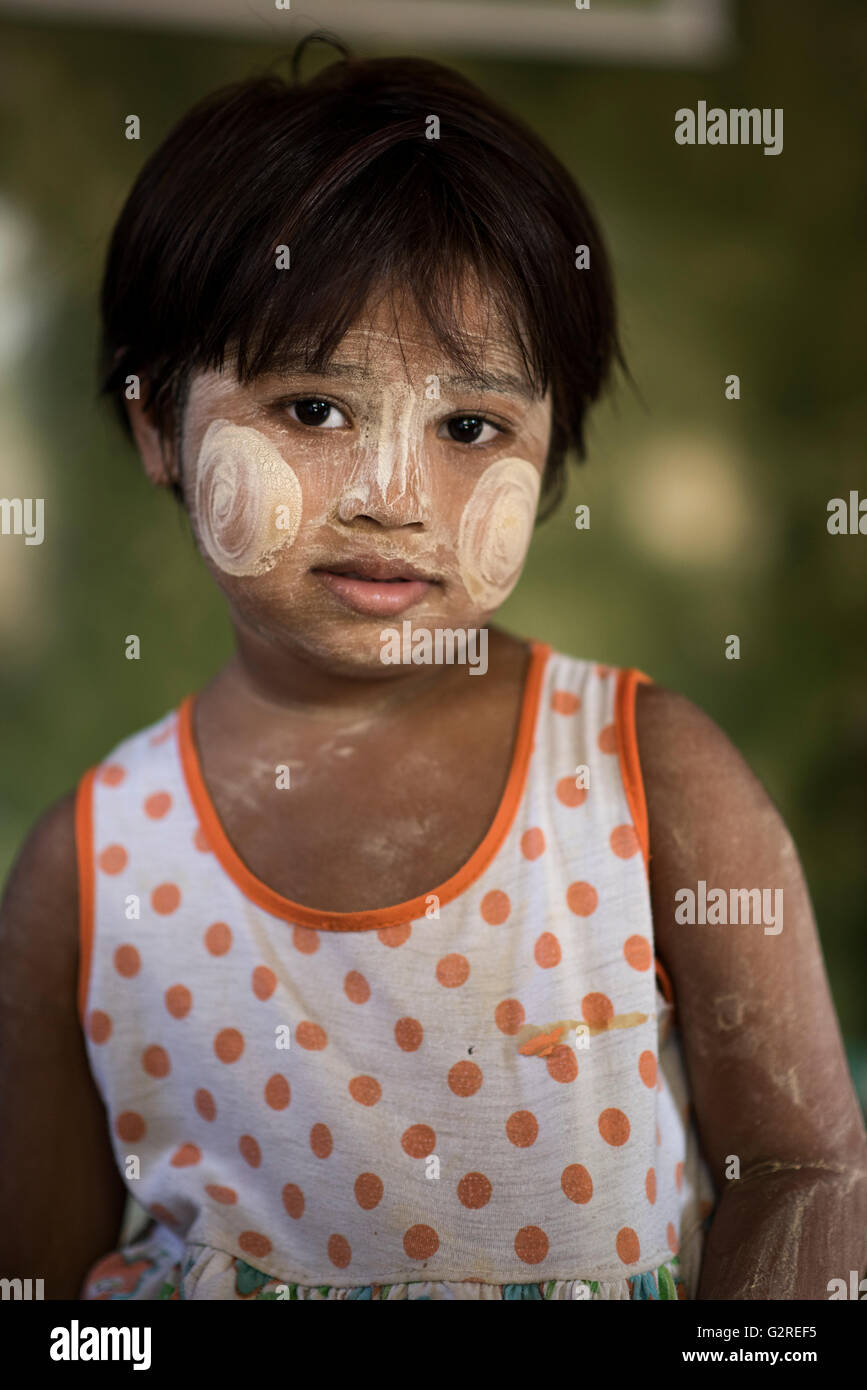 Portrait of a beautiful Burmese girl wearing traditional make-up ...