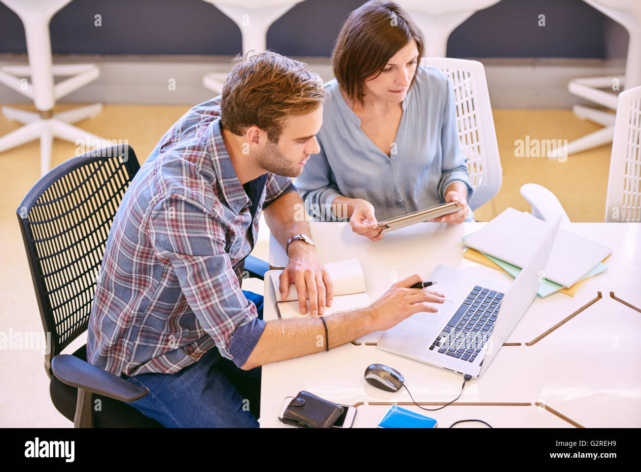 Male and female professional working together to achieve more Stock ...