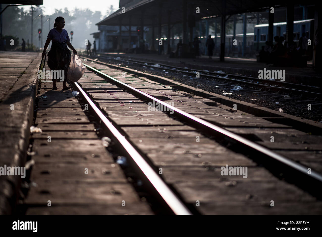 A garbage collector working at the rail tracks of the Yangon Central ...