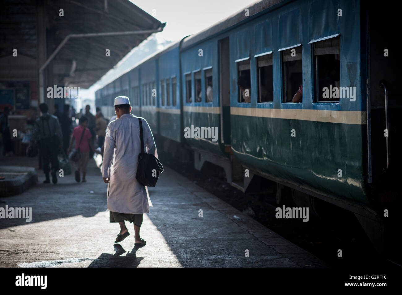 A Muslim man walking on the platform of the Yangon Central Train ...